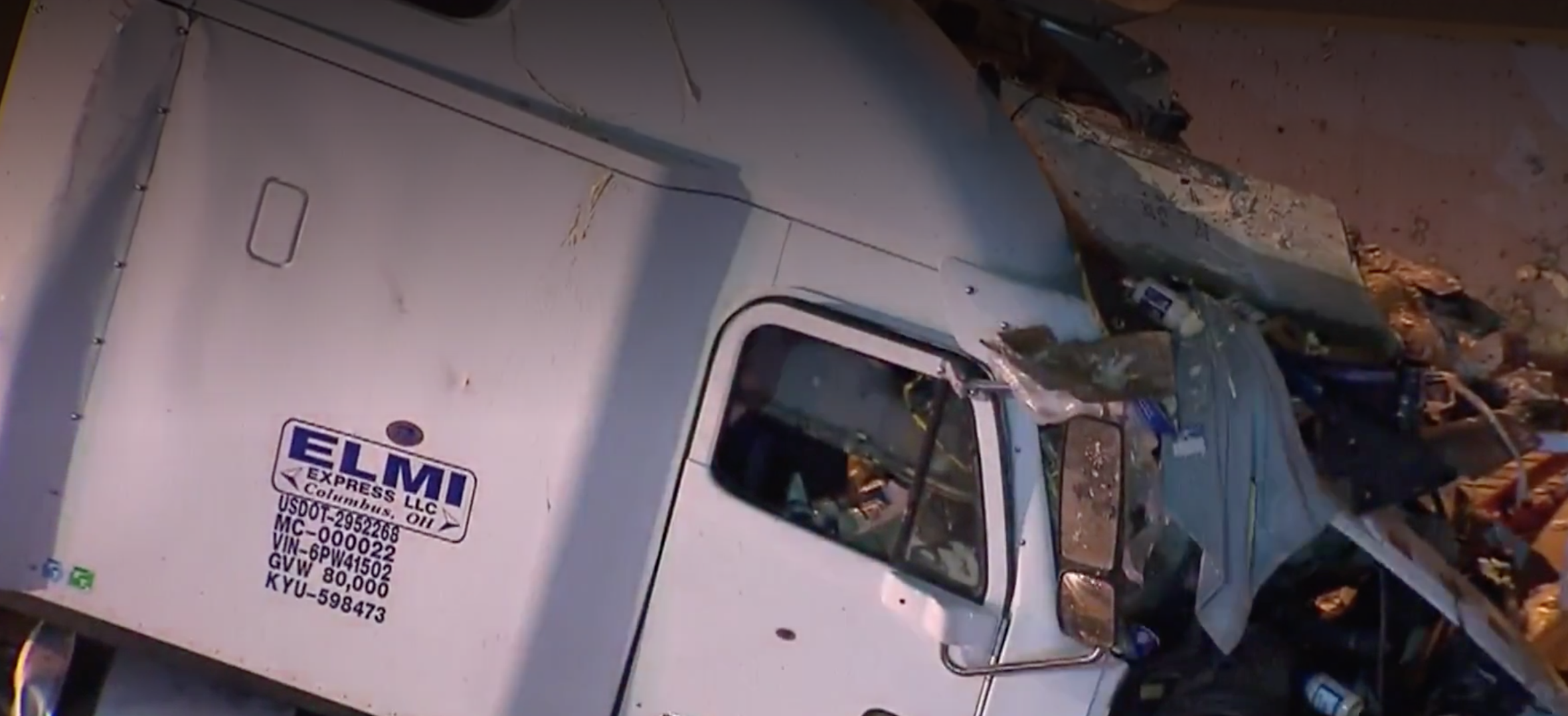 Truck cab leaves behind its trailer as it dangles off overpass