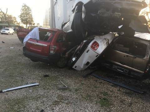 Truck runs over multiple cars at used auto dealership