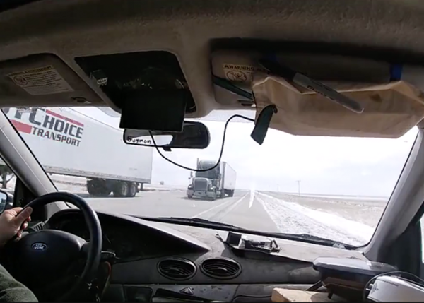 Semi truck 'plays chicken' with car driver in video clip