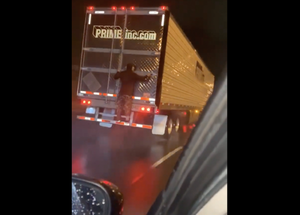 Man caught clinging to moving semi truck in viral video
