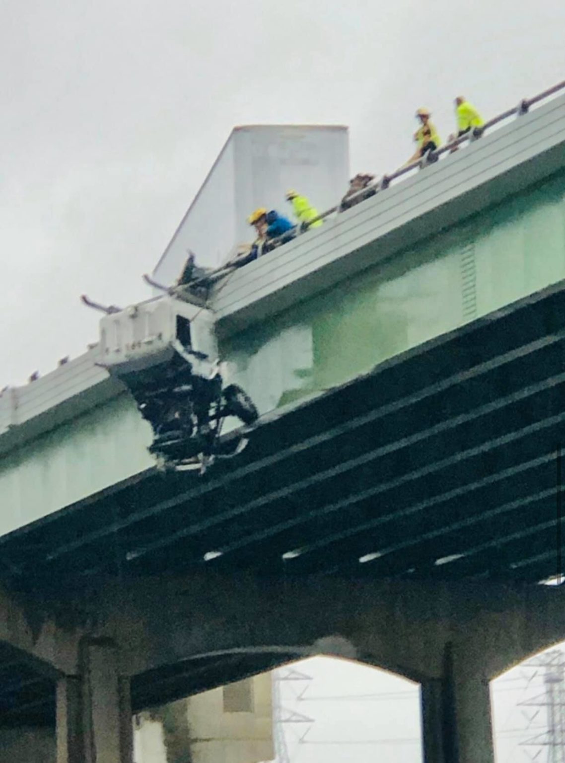 Trucker rescued from semi dangling from High Rise Bridge