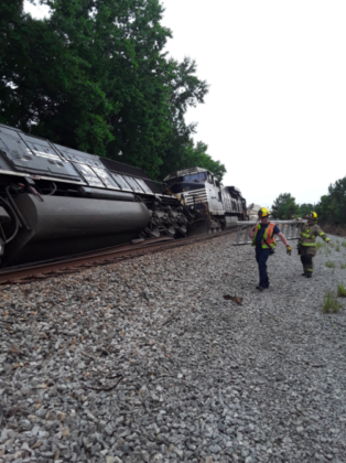A least 20 train cars derail after smashing into semi stuck on tracks