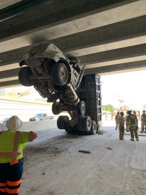 Overpass crash left dump truck driver up in the air