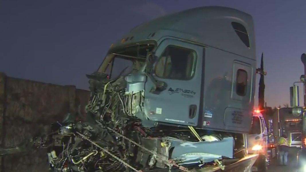 Driver walks away from rig mangled in wreck