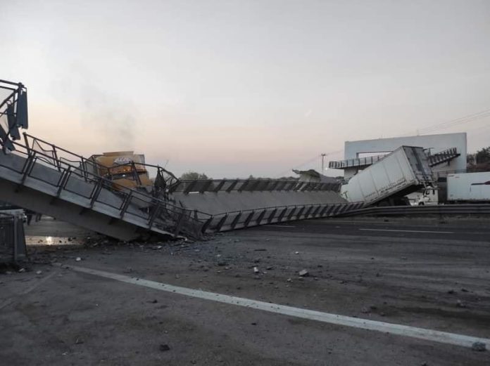 Two semi trucks crushed beneath collapsed pedestrian bridge