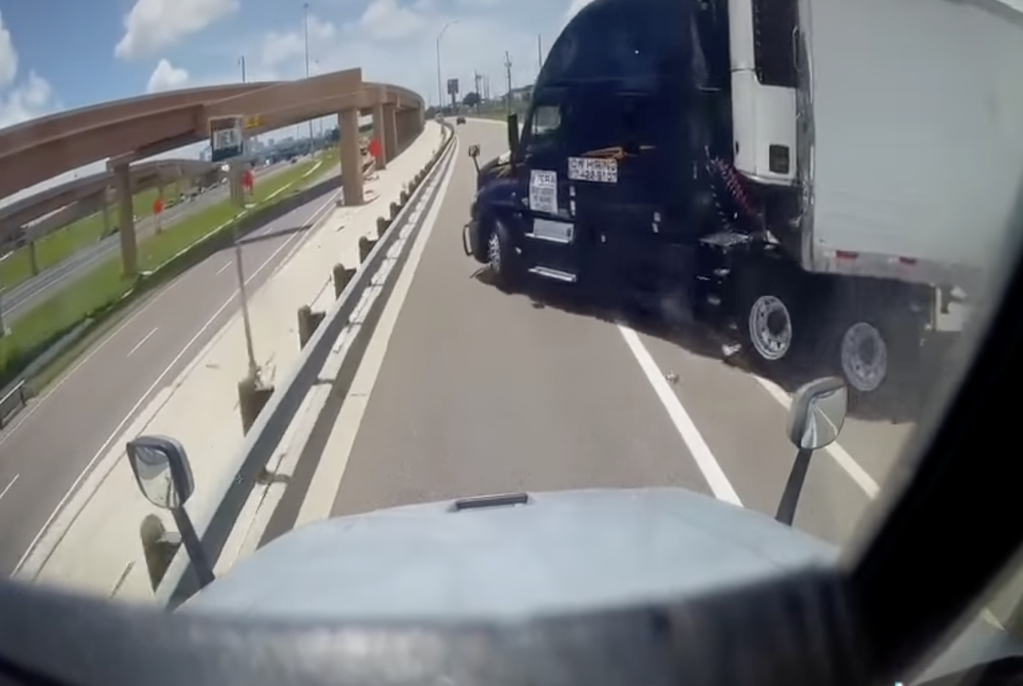 Watch as a merging semi swipes the dash cammer's hood