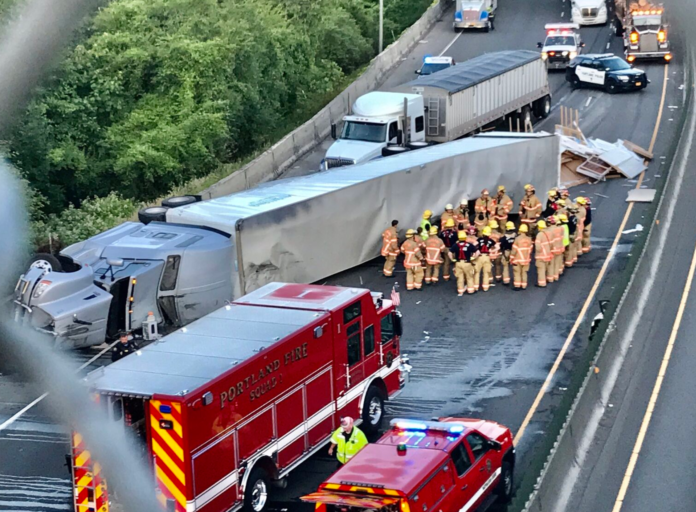 Overturned semi truck lands squarely on top of passing four-wheeler