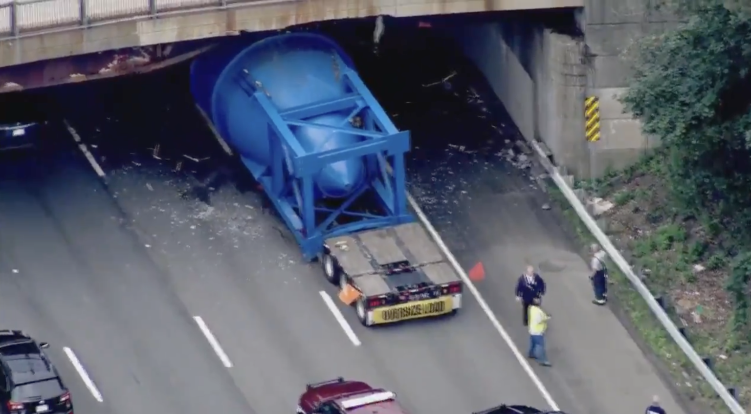 Oversized load strikes bridge, gets wedged underneath