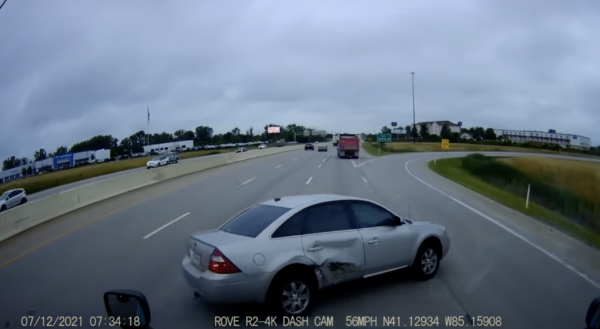 Watch as an out of control car gives a trucker a big scare