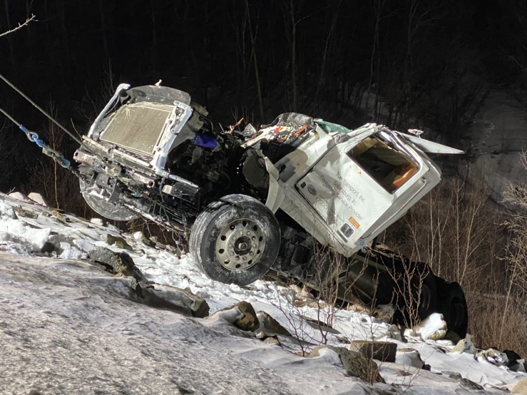 Abandoned vehicle sends big rig down steep embankment