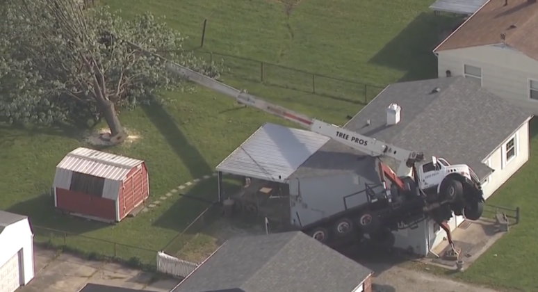 Crane collapse pulls truck on top of home
