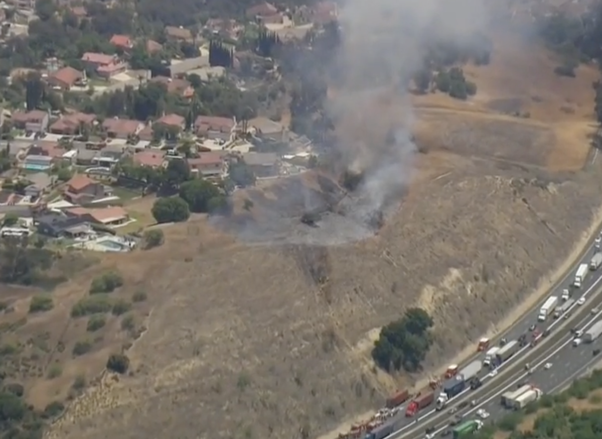 Flaming big rig sparks neighborhood brush fire