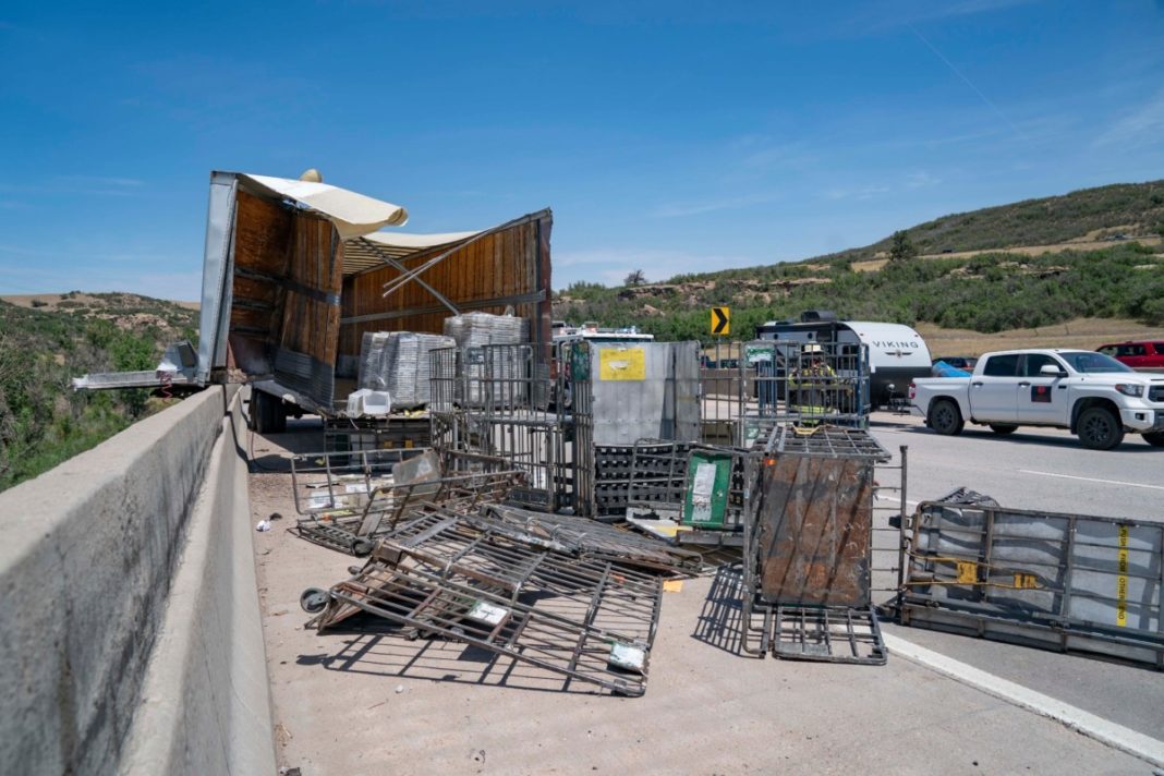 Loose trailer spills load of storage racks, injuring two
