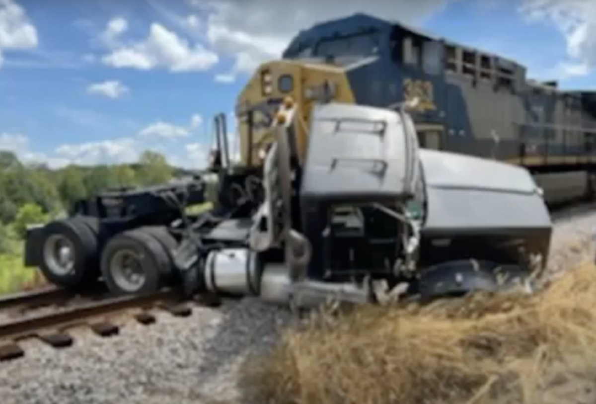WATCH: Driver frantically waves at conductor moments before train plows ...