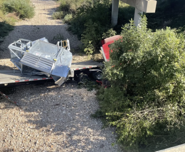 Big rig plows through guardrail only to land in dry creek bed below