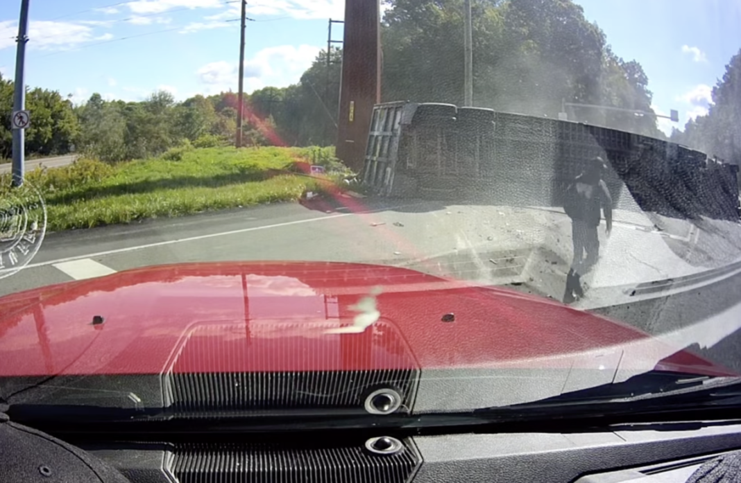 WATCH: Trucker rushes to help fellow driver who took turn too fast