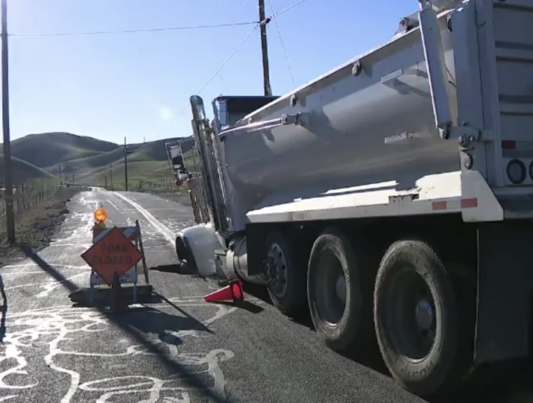 Dump truck falls into sink hole after ignoring road closure