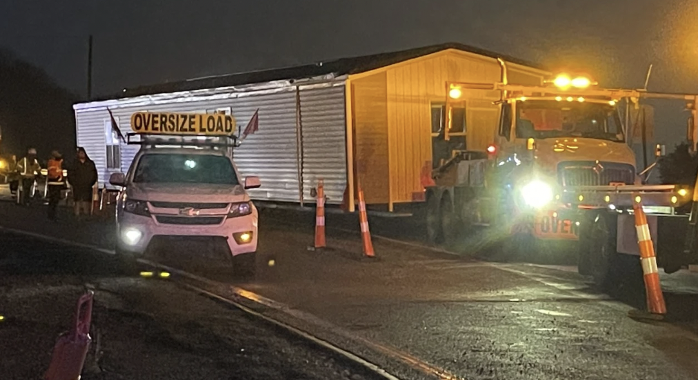 Mobile home slips off tractor trailer in transit