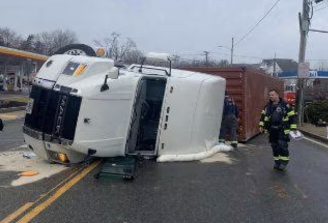 Van smashes into gas station while avoiding overturned rig