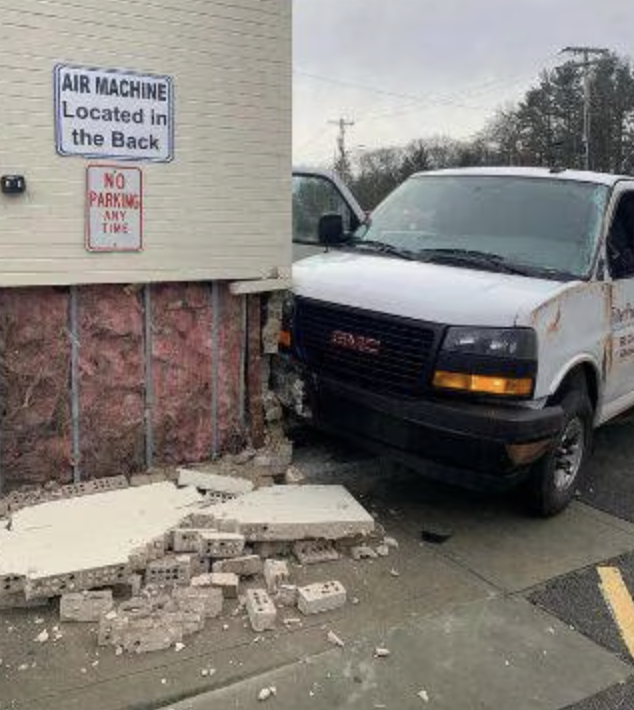 Van smashes into gas station while avoiding overturned rig