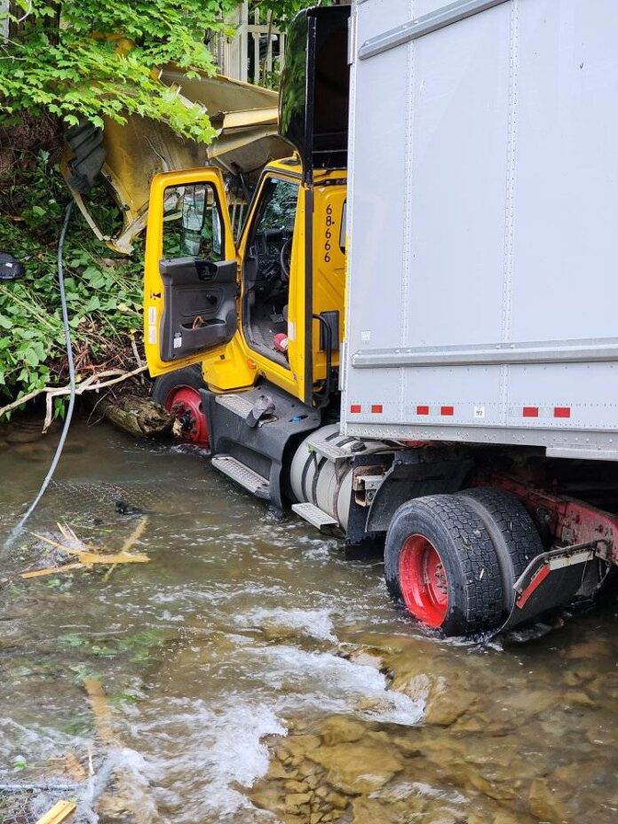 Trucker ticketed for brake defect following crash into creek