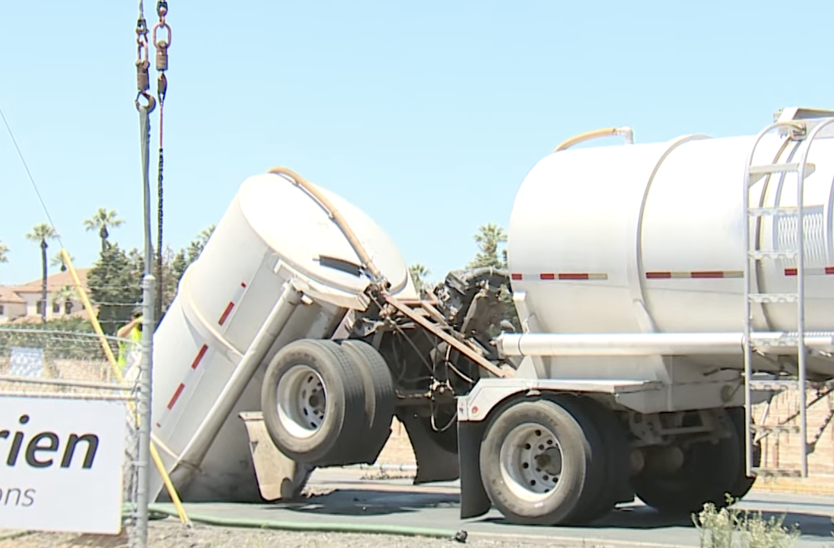 Sinkhole completely swallows rear trailer as semi hauls double tankers