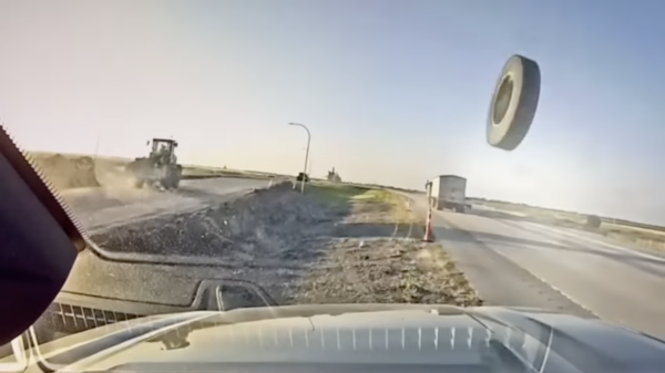 Dash cam catches semi trailer wheel detaching, hitting construction vehicle
