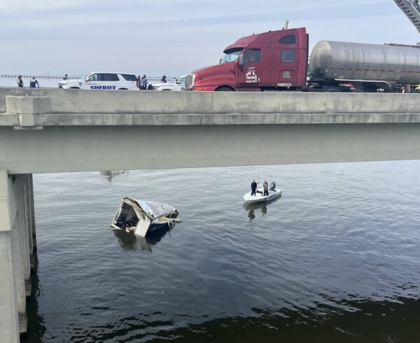 Trucker pulled from water alive after semi truck plummets off Twin Span ...
